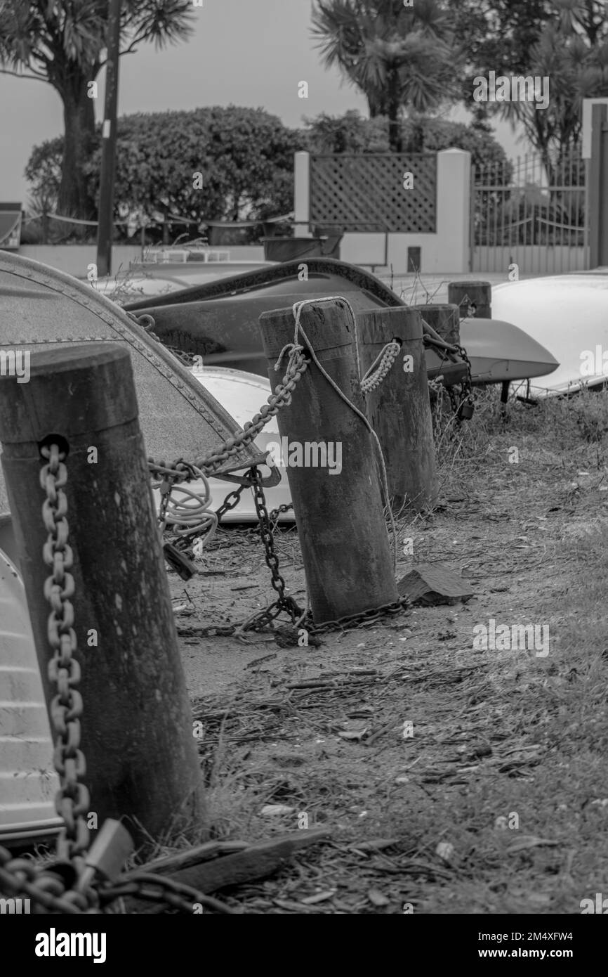 boats chained to a fence awaiting use Stock Photo - Alamy