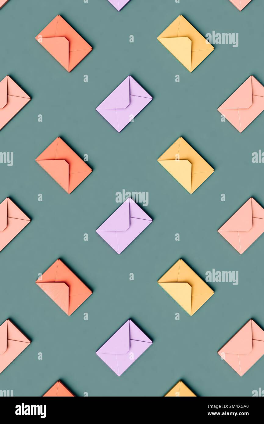 Three dimensional pattern of rows of pastel colored envelopes flat laid ...