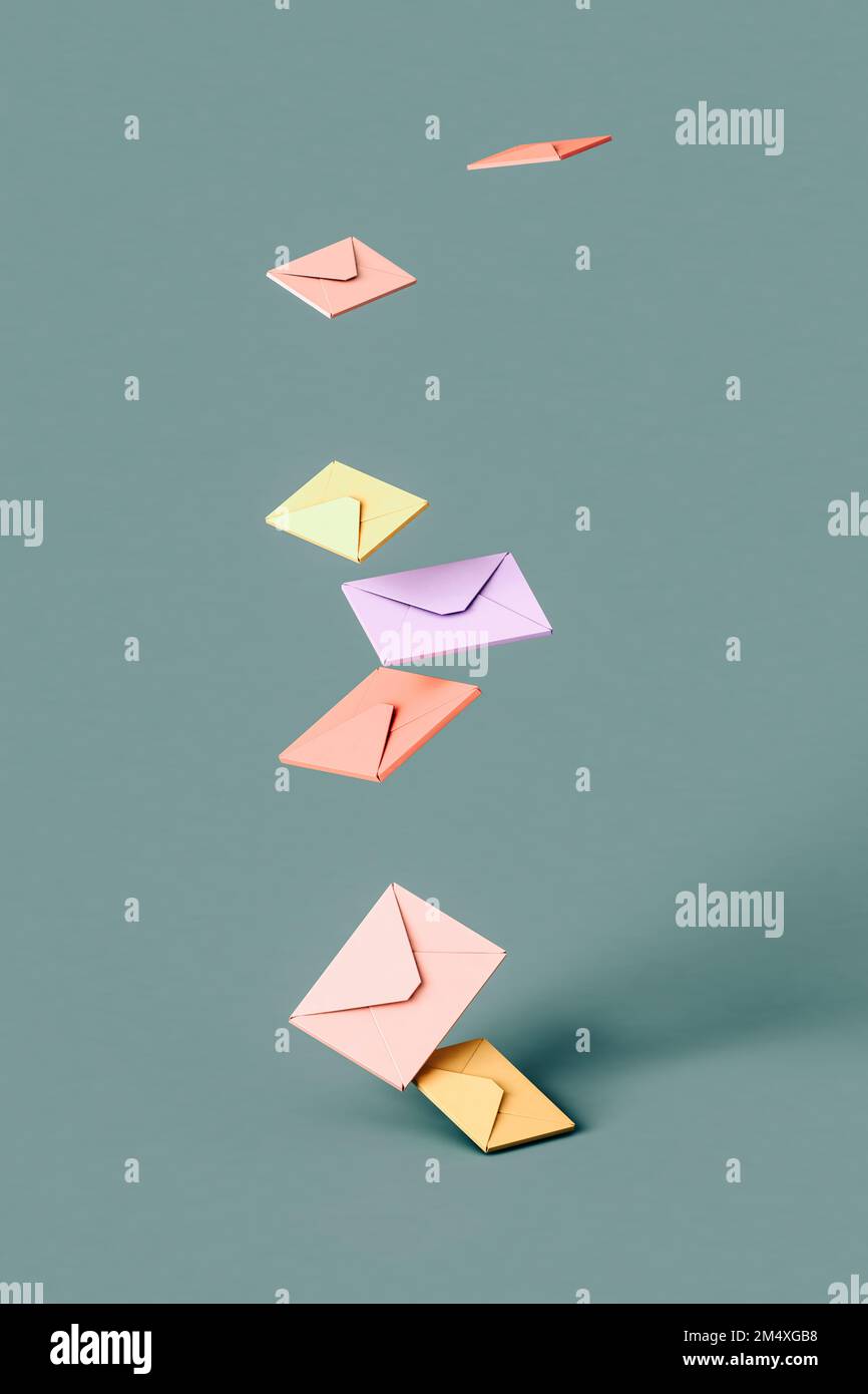 Three dimensional render of pastel colored envelopes falling down ...