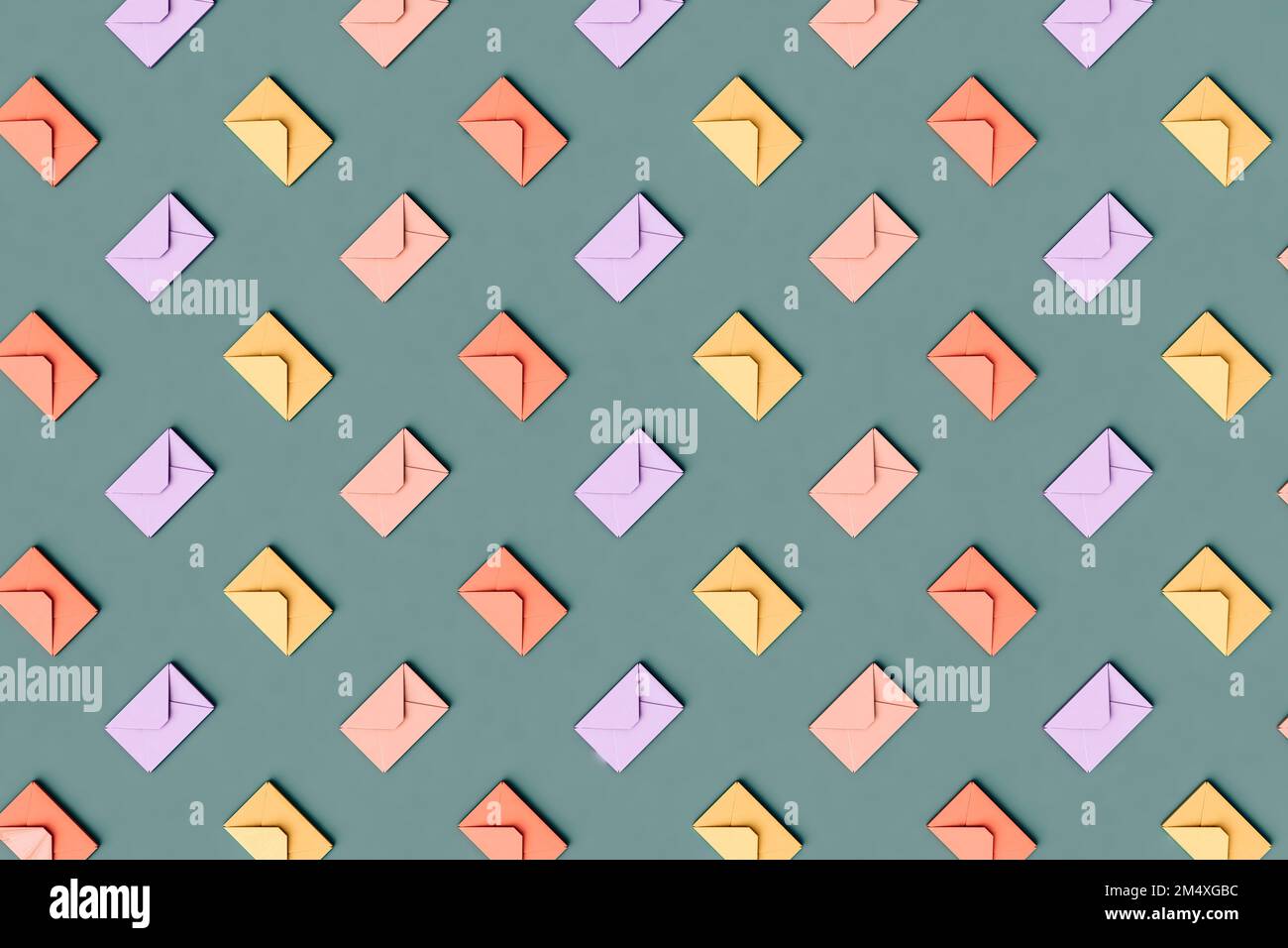 Three dimensional pattern of rows of pastel colored envelopes flat laid ...
