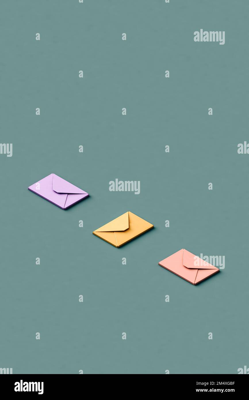 Three dimensional render of row of pastel colored envelopes flat laid ...