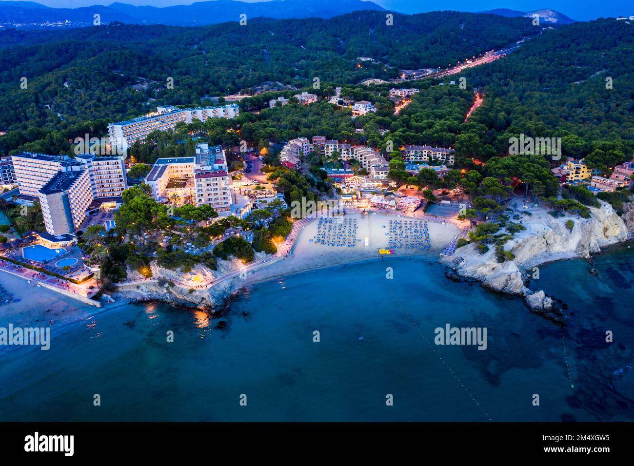 Aerial view of coastal town Paguera by sea at night in Balearic Islands ...