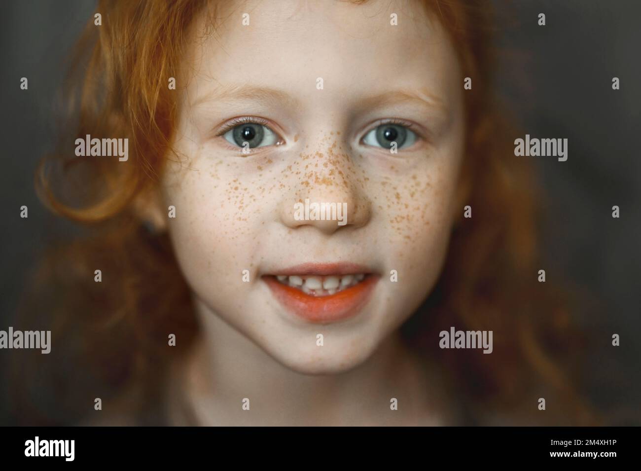 Smiling cute girl with freckles on face Stock Photo - Alamy