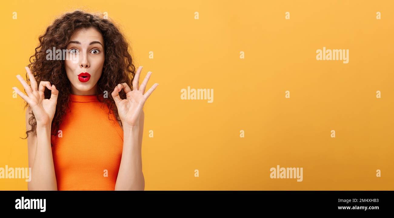 Enthusiastic charming caucasian girl with curly hairstyle in red ...