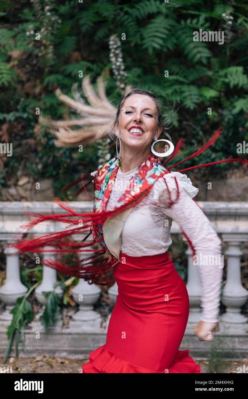 Happy female dancer dancing in front of trees Stock Photo - Alamy