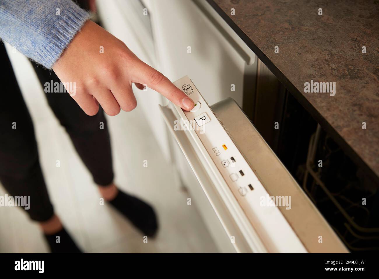 Finger of girl turning off dishwasher at home Stock Photo - Alamy