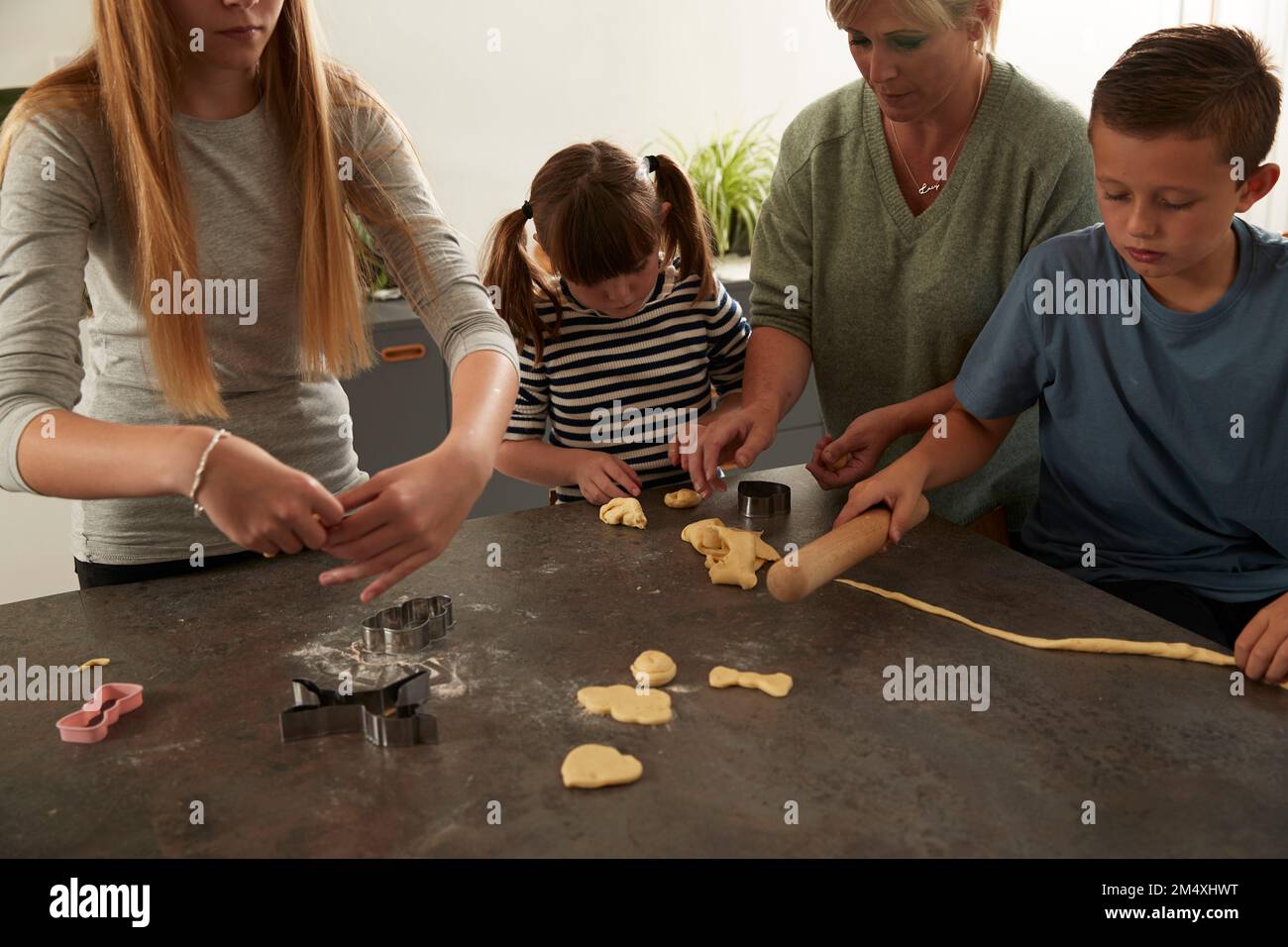 Family with dough preparing cookies together at home Stock Photo - Alamy