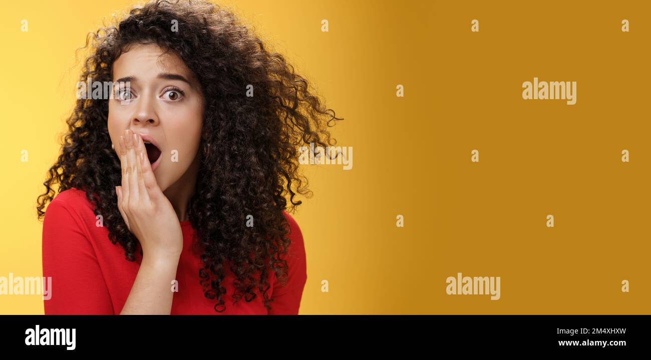 Close-up shot of concerned and shocked worried woman with curly ...