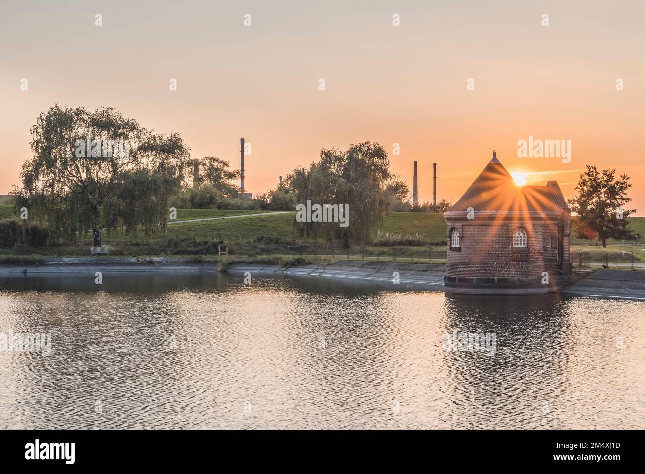 Germany, Hamburg, Historic filter house on Kaltehofe island at sunset ...