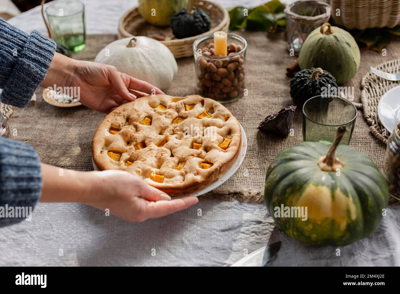 Hands of woman picking up plate with homemade pumpkin pie Stock Photo ...