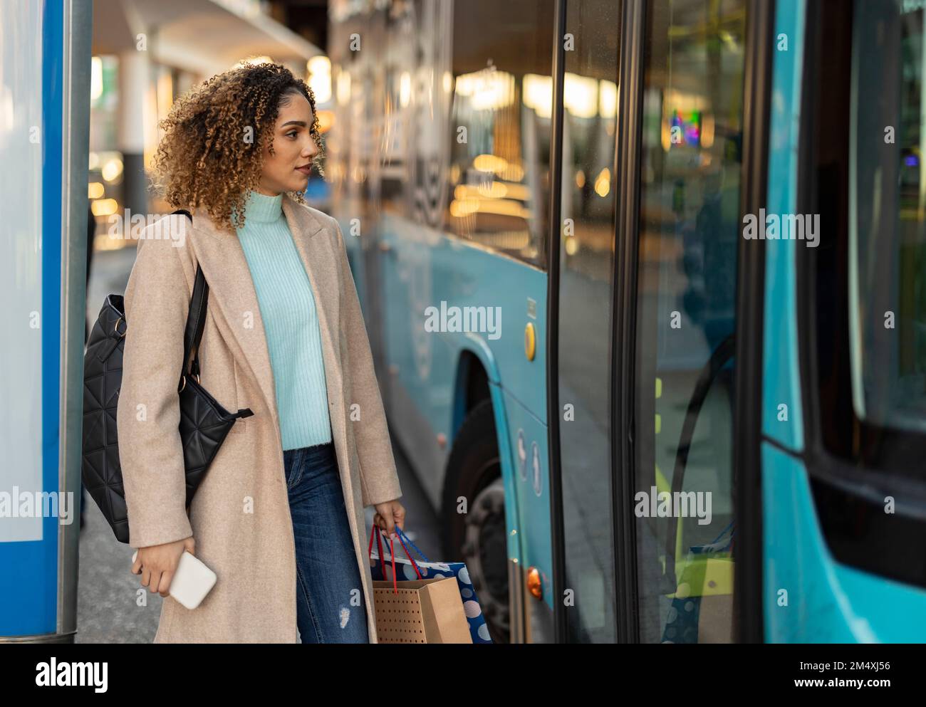 Woman standing bus stop hi-res stock photography and images - Alamy