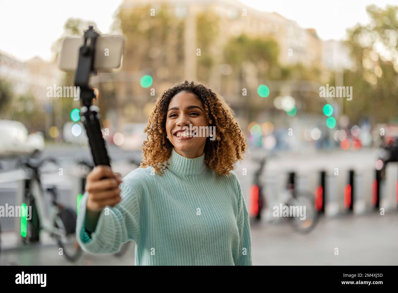 Happy woman filming through smart phone on tripod Stock Photo - Alamy