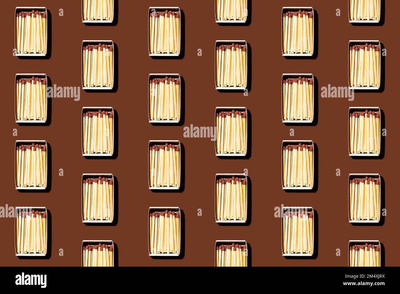 Pattern of rows of matchboxes flat laid against brown background Stock ...