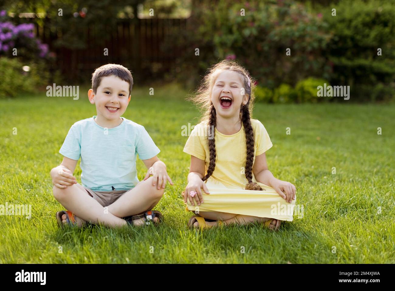 Back view brother sister sitting hi-res stock photography and images ...