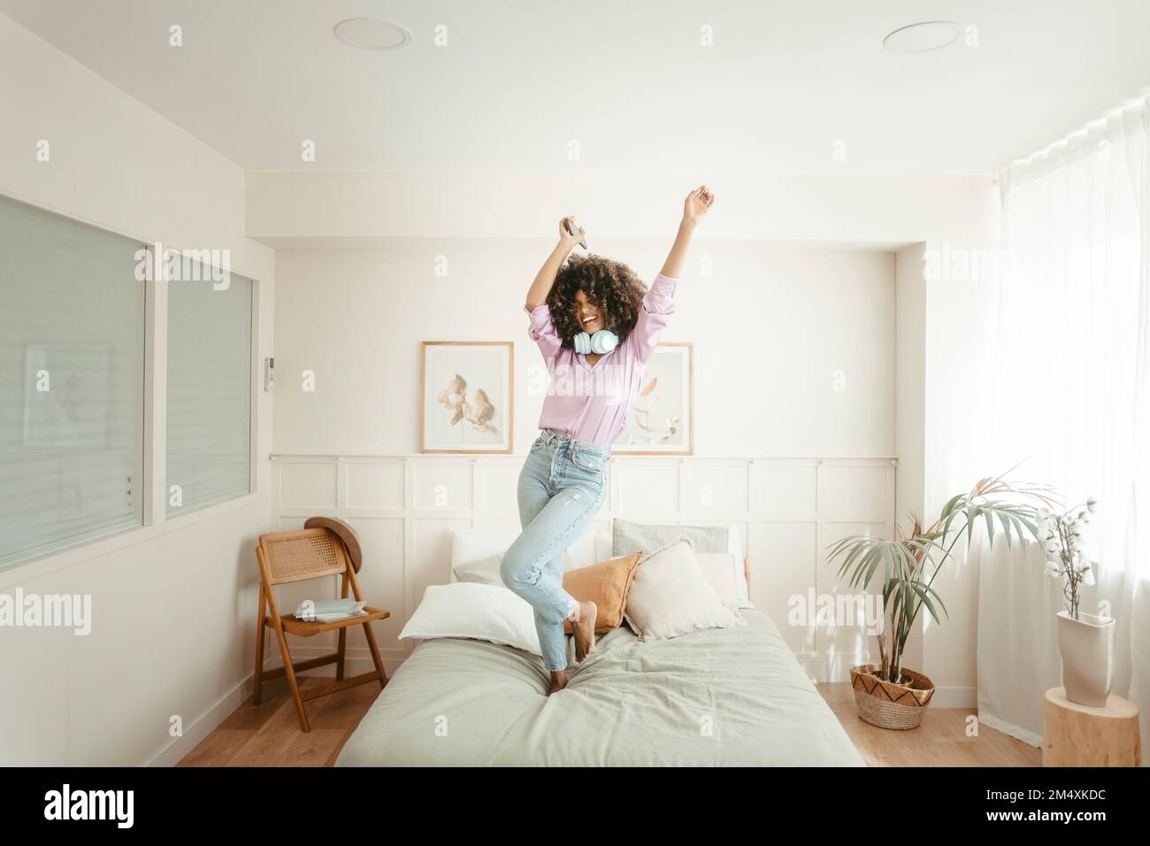 Woman dancing on bed hi-res stock photography and images - Alamy