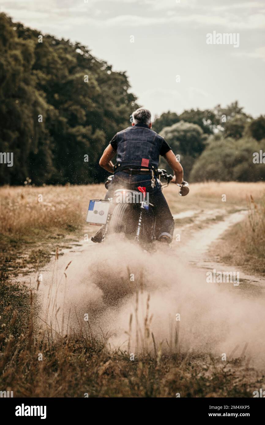 Rear view man riding motorcycle hi-res stock photography and images - Alamy