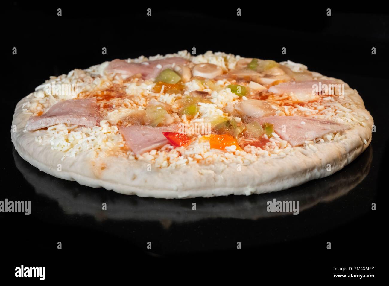 Uncooked homemade pizza on tray in electric oven, black background ...