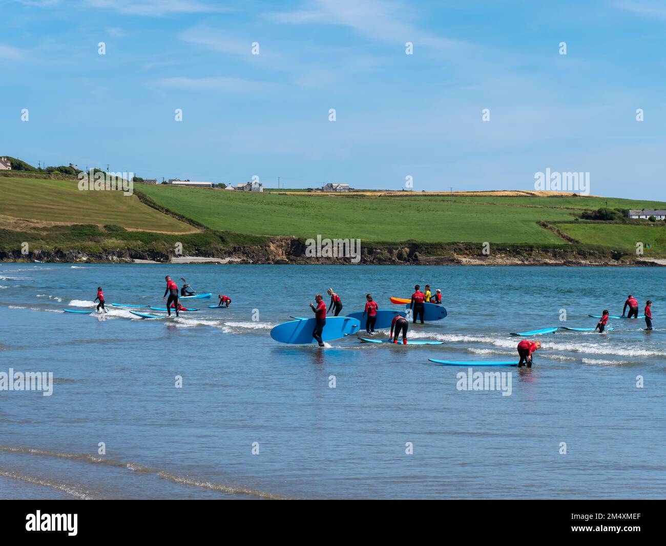 County Cork, Ireland, August 6, 2022. Young people are surfing. A surf ...