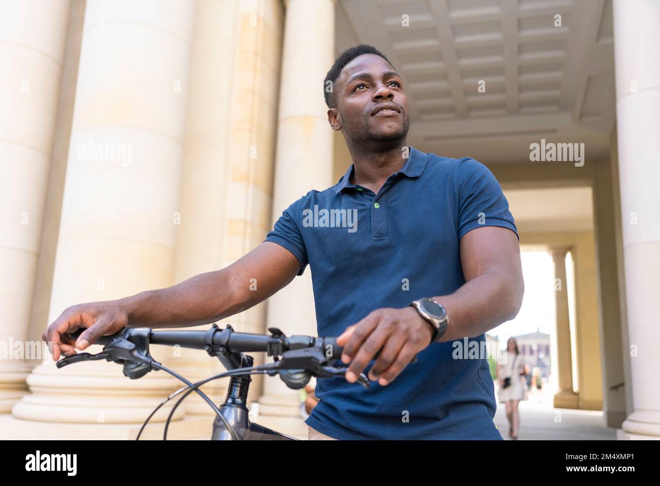 Man wheeling bike hi-res stock photography and images - Alamy