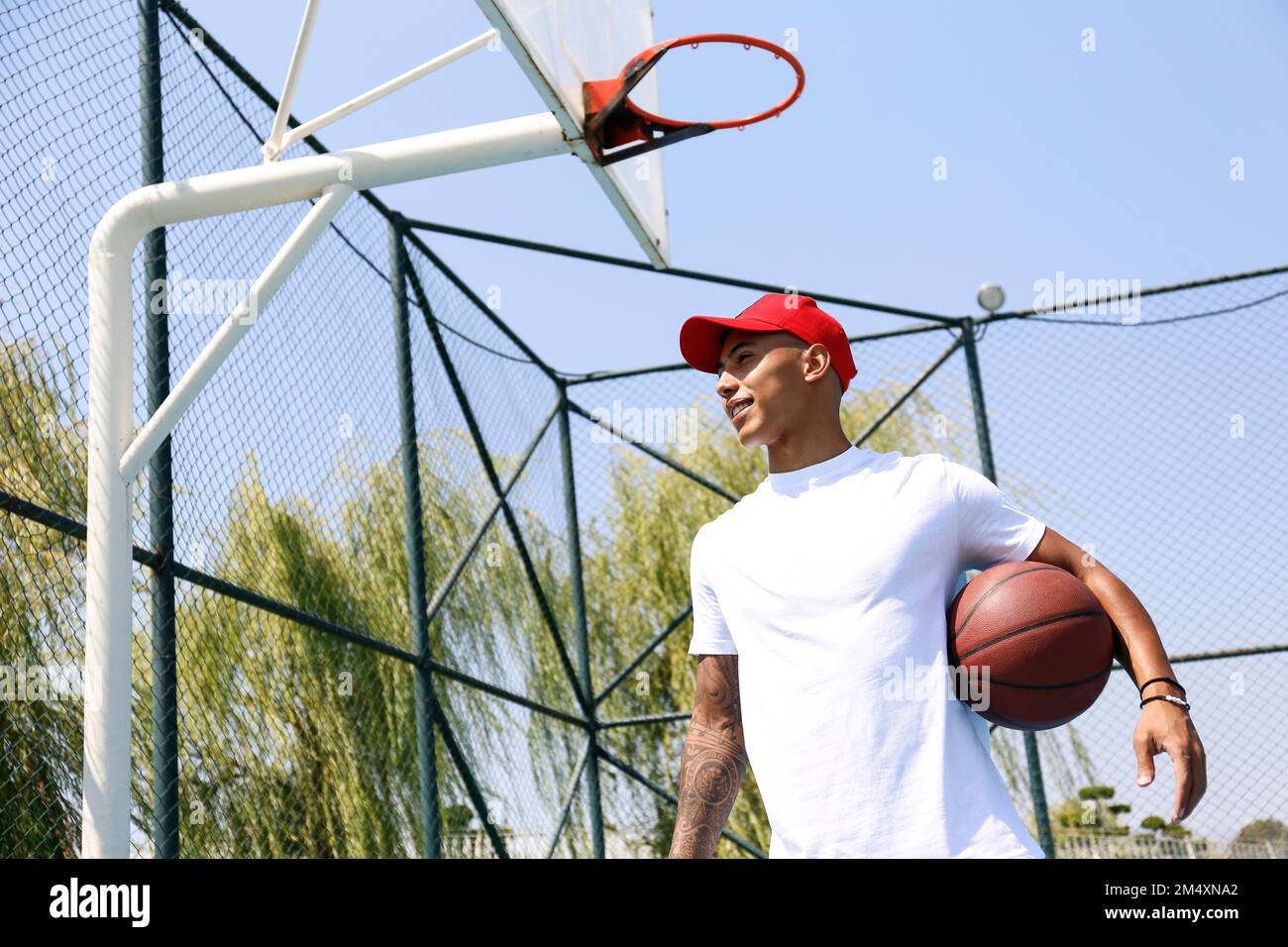 Man with basketball under arm hi-res stock photography and images - Alamy