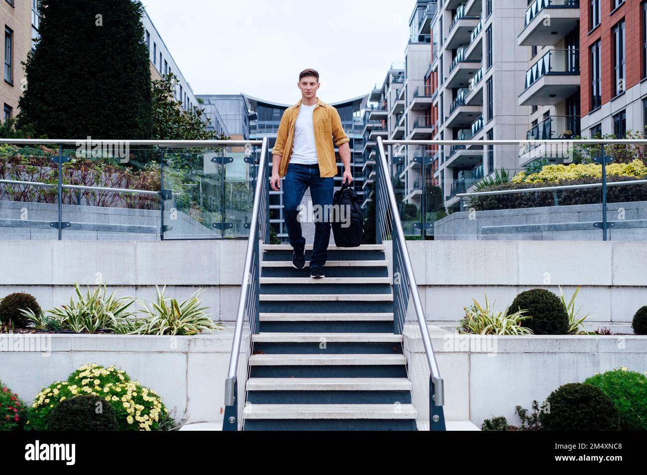 Man moving down staircase architecture hi-res stock photography and ...