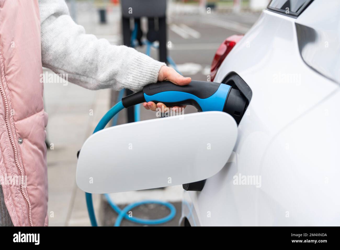 Woman plugging in charger hi-res stock photography and images - Alamy