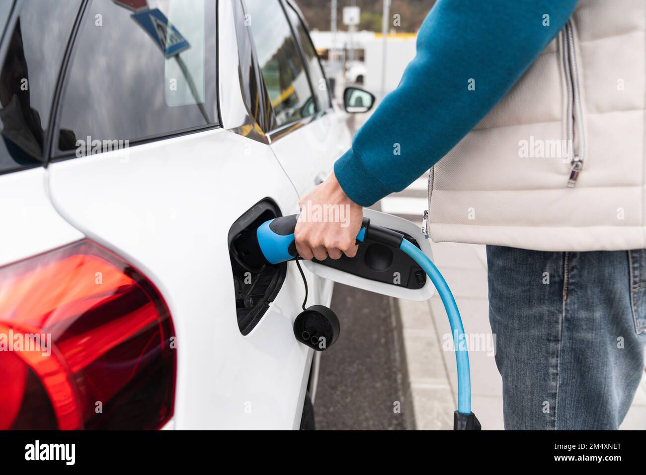 Mid adult man charging electric car hi-res stock photography and images ...