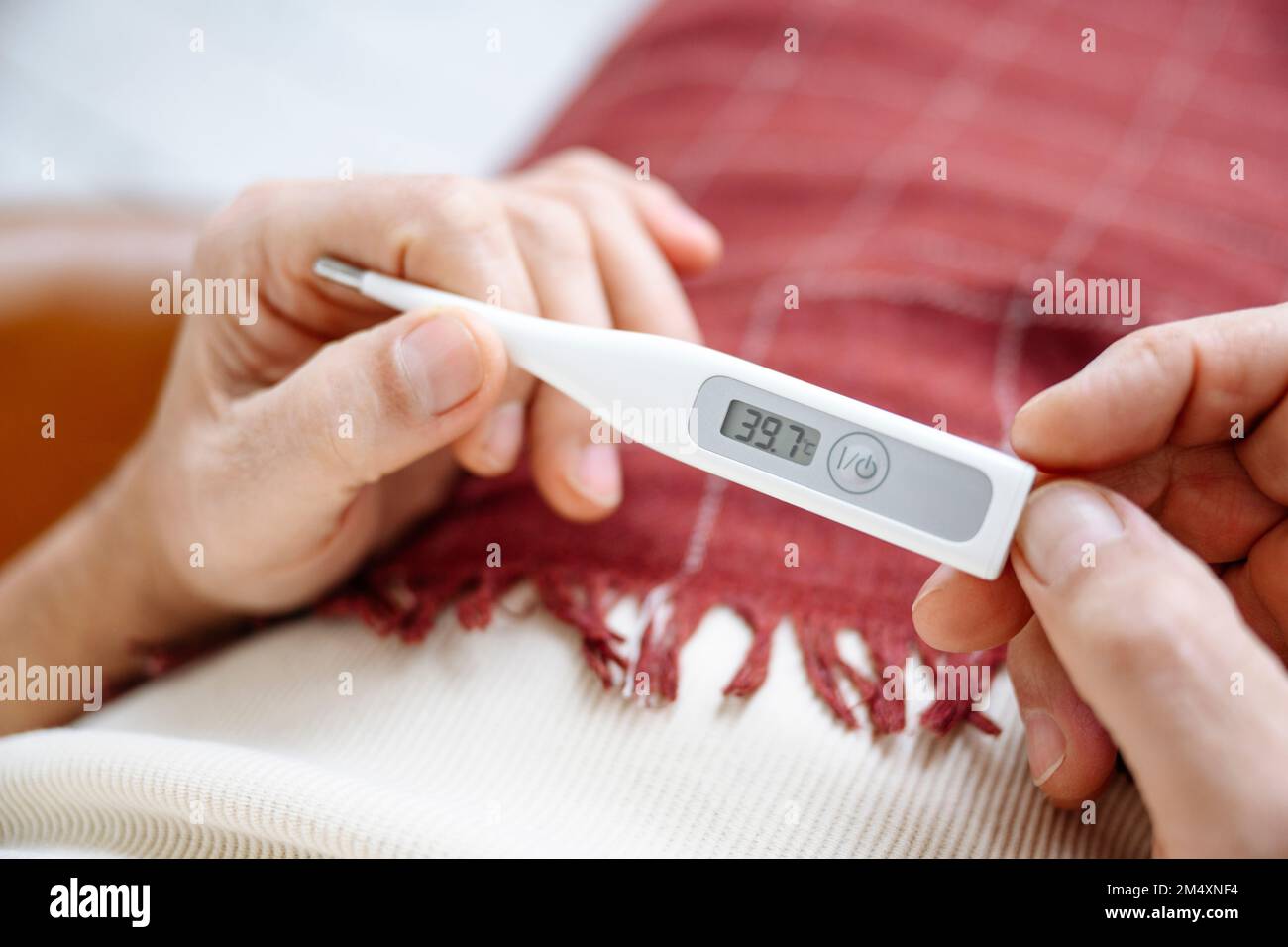 Man checking temperature using thermometer Stock Photo - Alamy