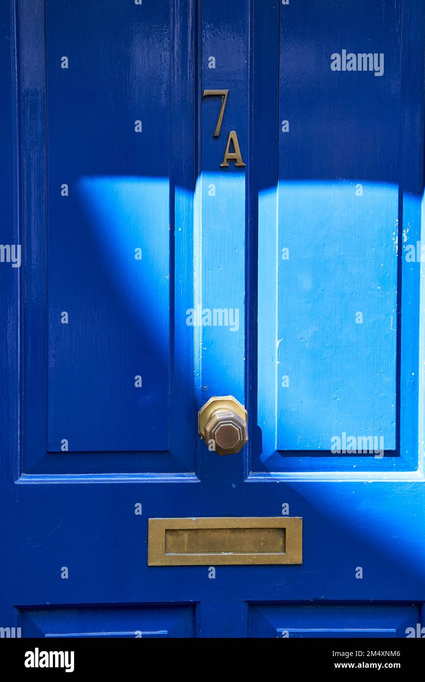 Sunlight on blue wooden house door Stock Photo - Alamy