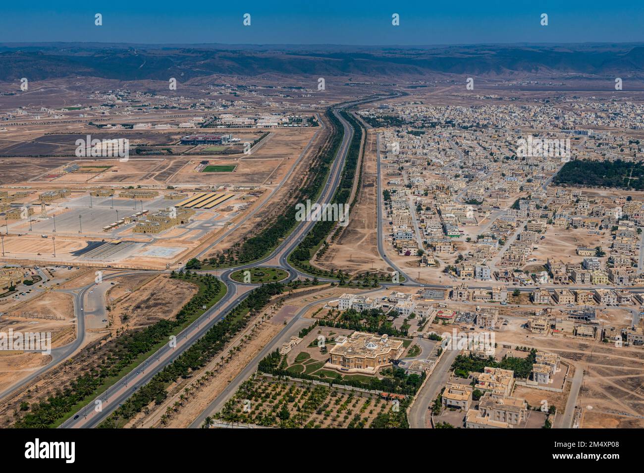 Oman, Dhofar Governorate, Salalah, Aerial view of long road stretching ...