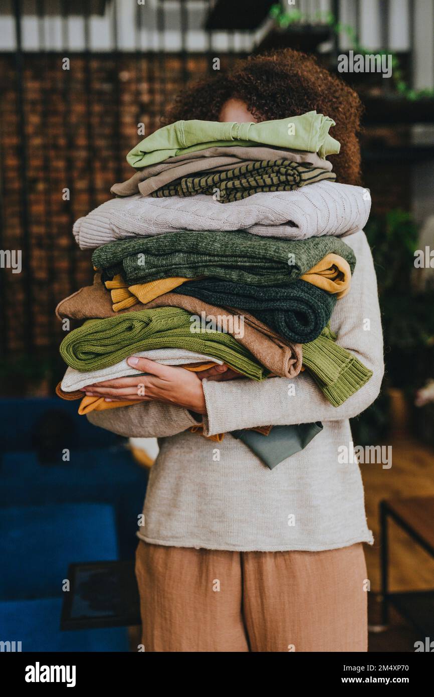 Fashion designer standing with clothes Stock Photo - Alamy