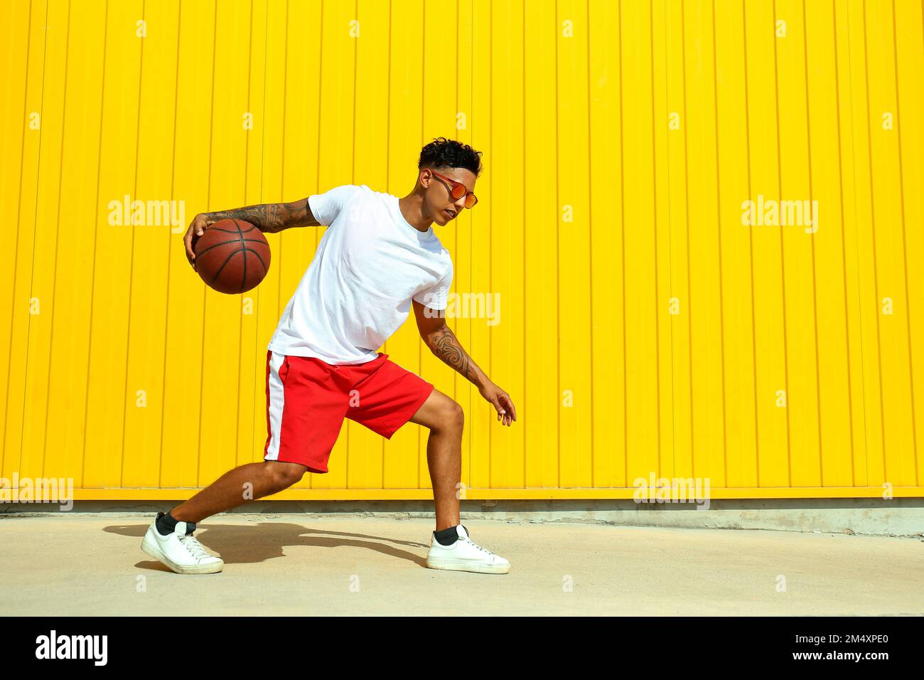 Young man in light yellow hi-res stock photography and images - Alamy