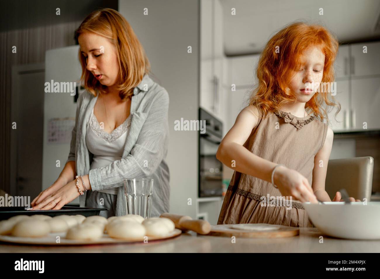 Mother and daughter making cheesecake at home Stock Photo - Alamy