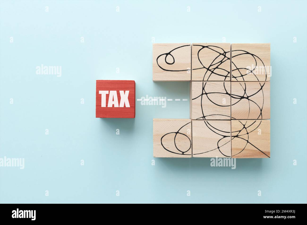 Messy line sketched on wooden blocks leading to red block with tax ...