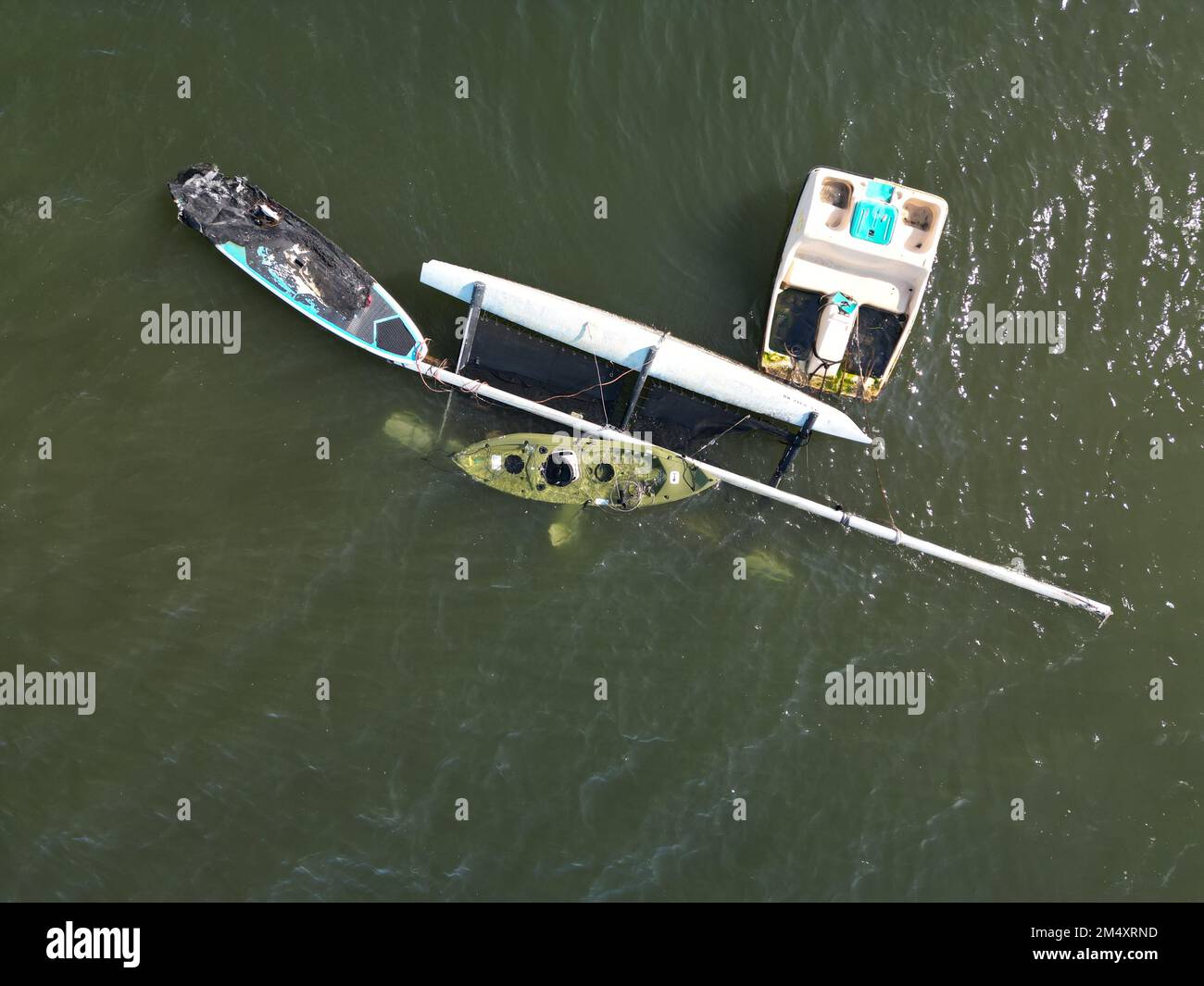 Aerial view looking straight down from above at capsized boats that ...
