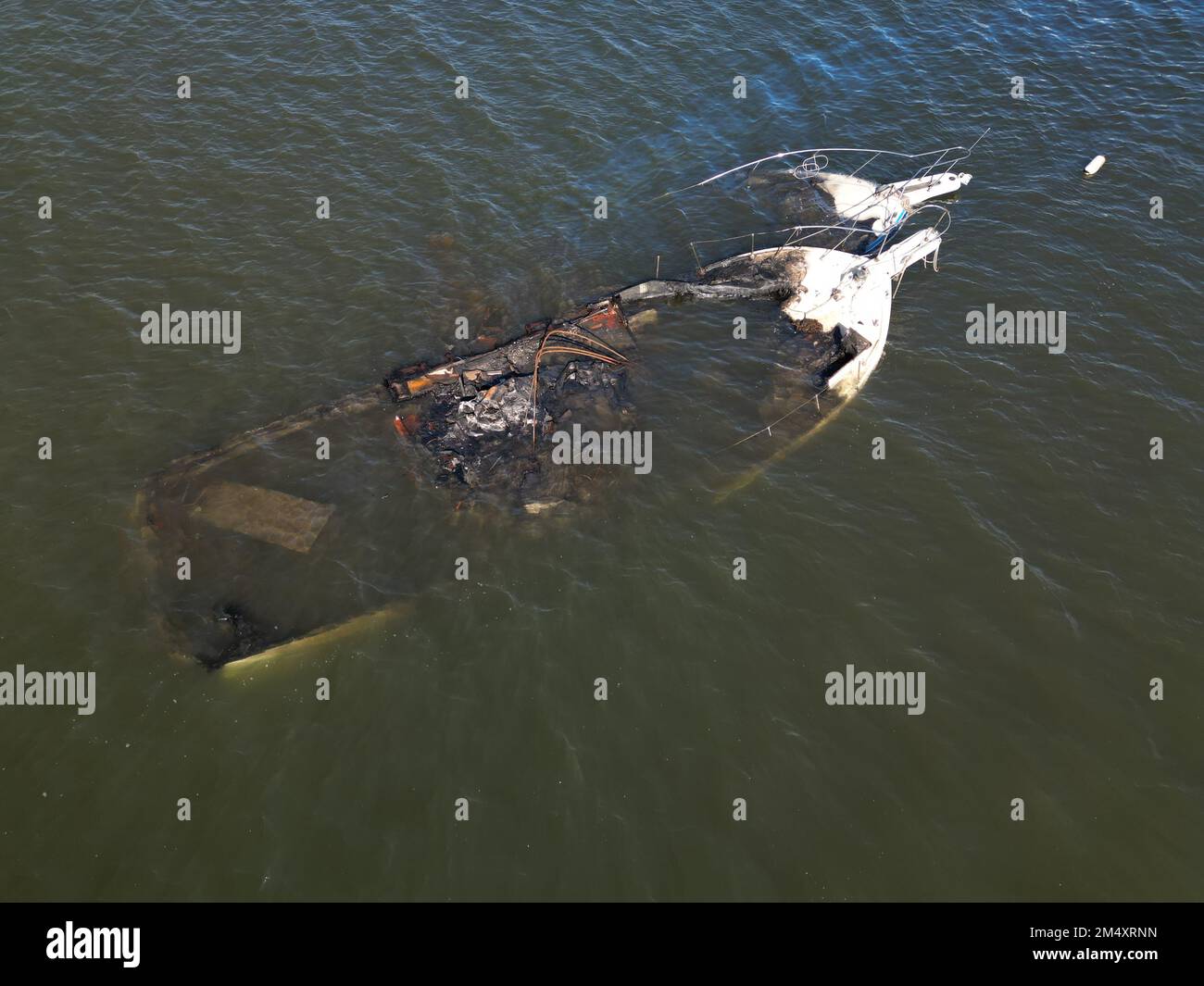 Aerial view looking straight down from above at capsized boats that ...