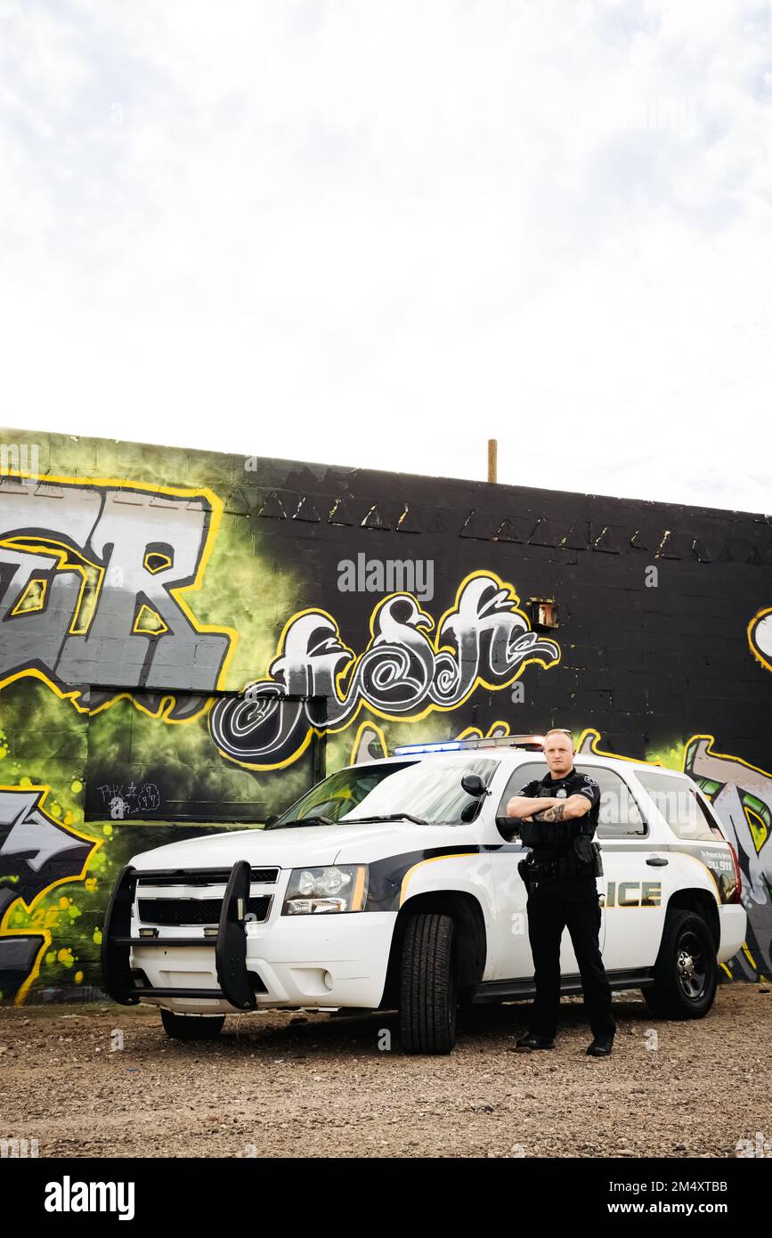 Vertical image of white male caucasian police officer with arms crossed ...