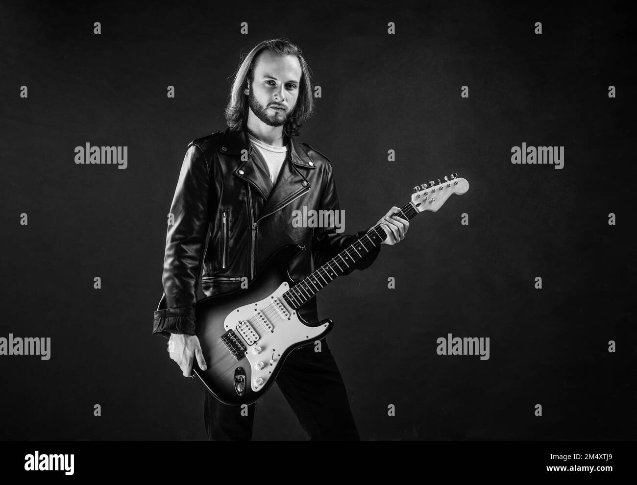 bearded rock musician playing electric guitar in leather jacket, rocker ...