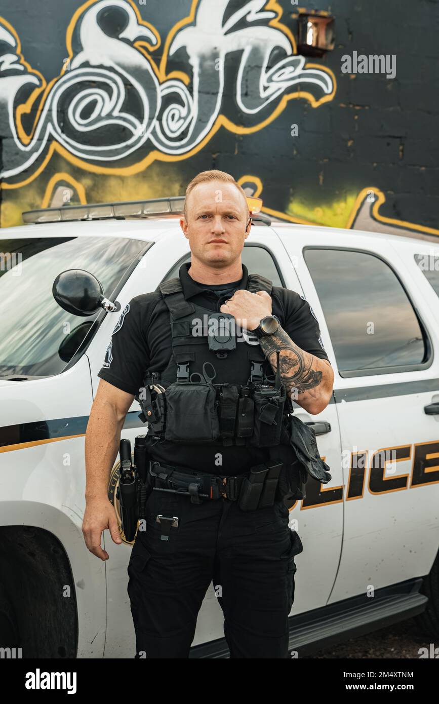 Vertical image of white male caucasian police officer posing with ...