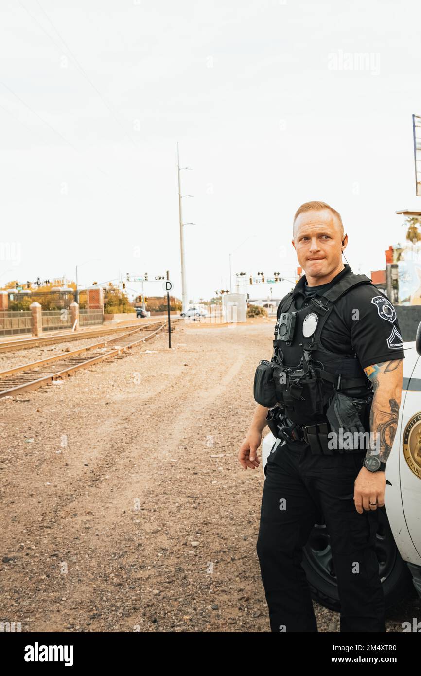 Vertical image of white male caucasian police officer standing next to ...