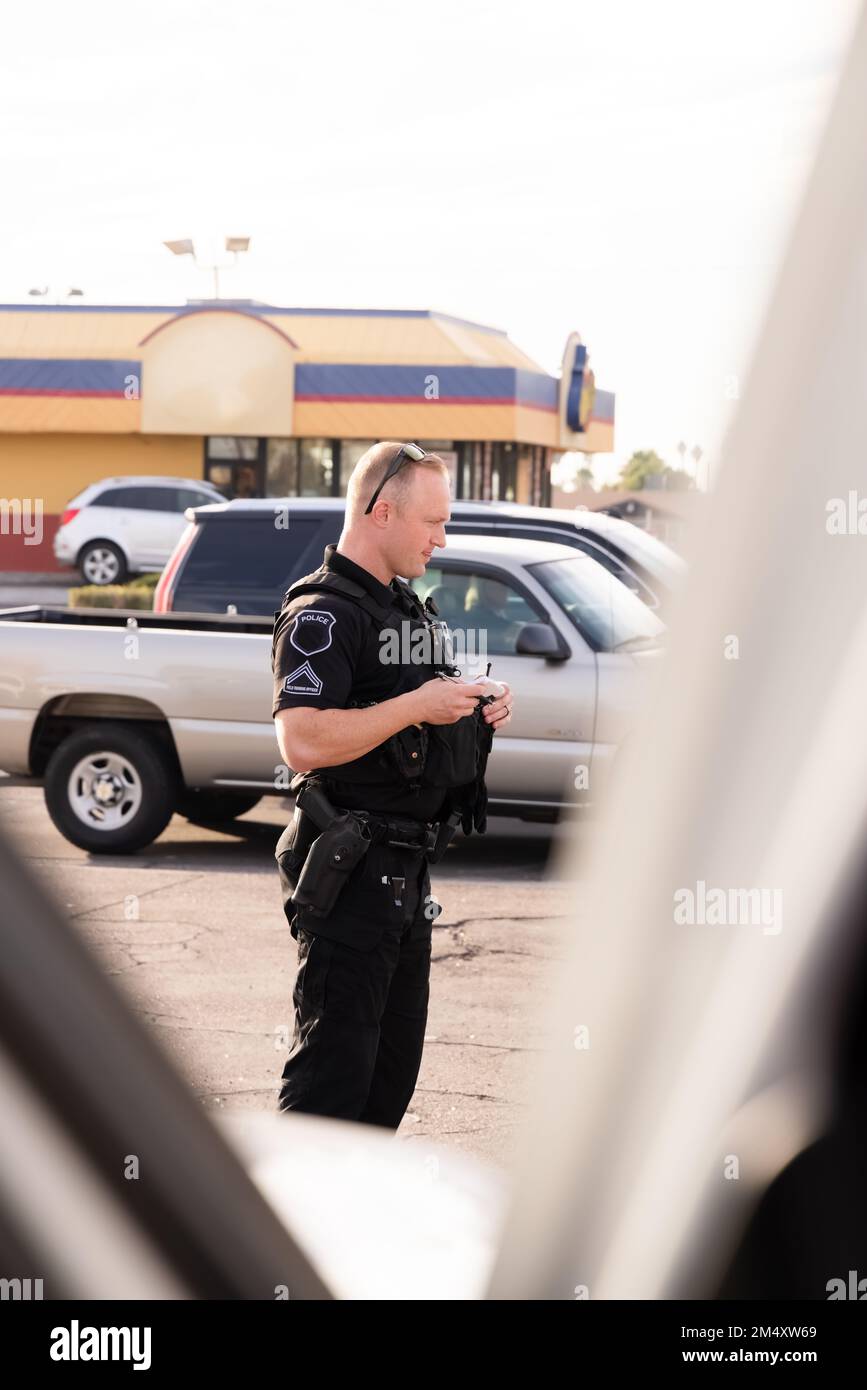 White male caucasian police officer cop trooper standing on street with ...