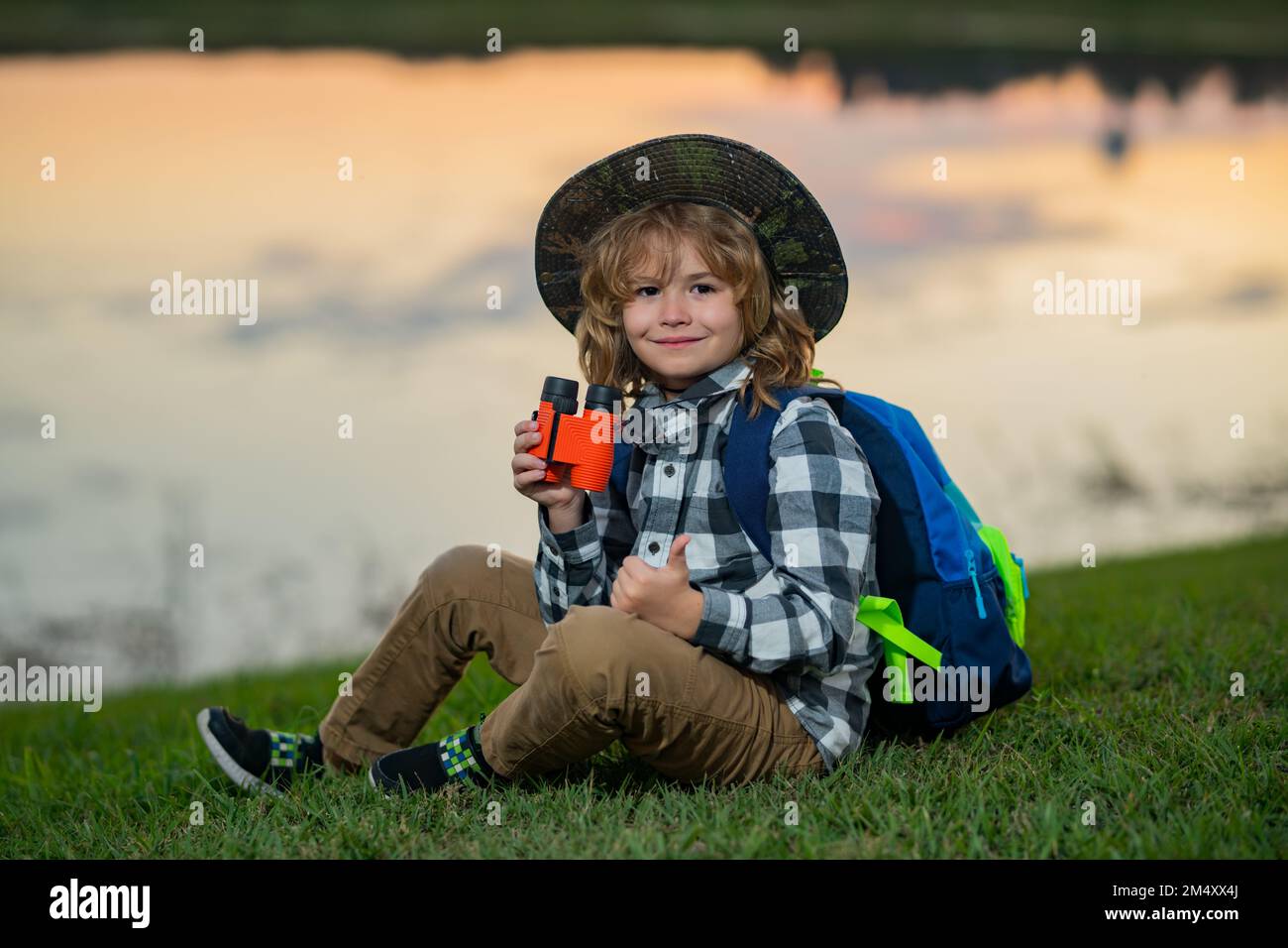 Happy child playing with binoculars. Explore and adventure. Child boy ...