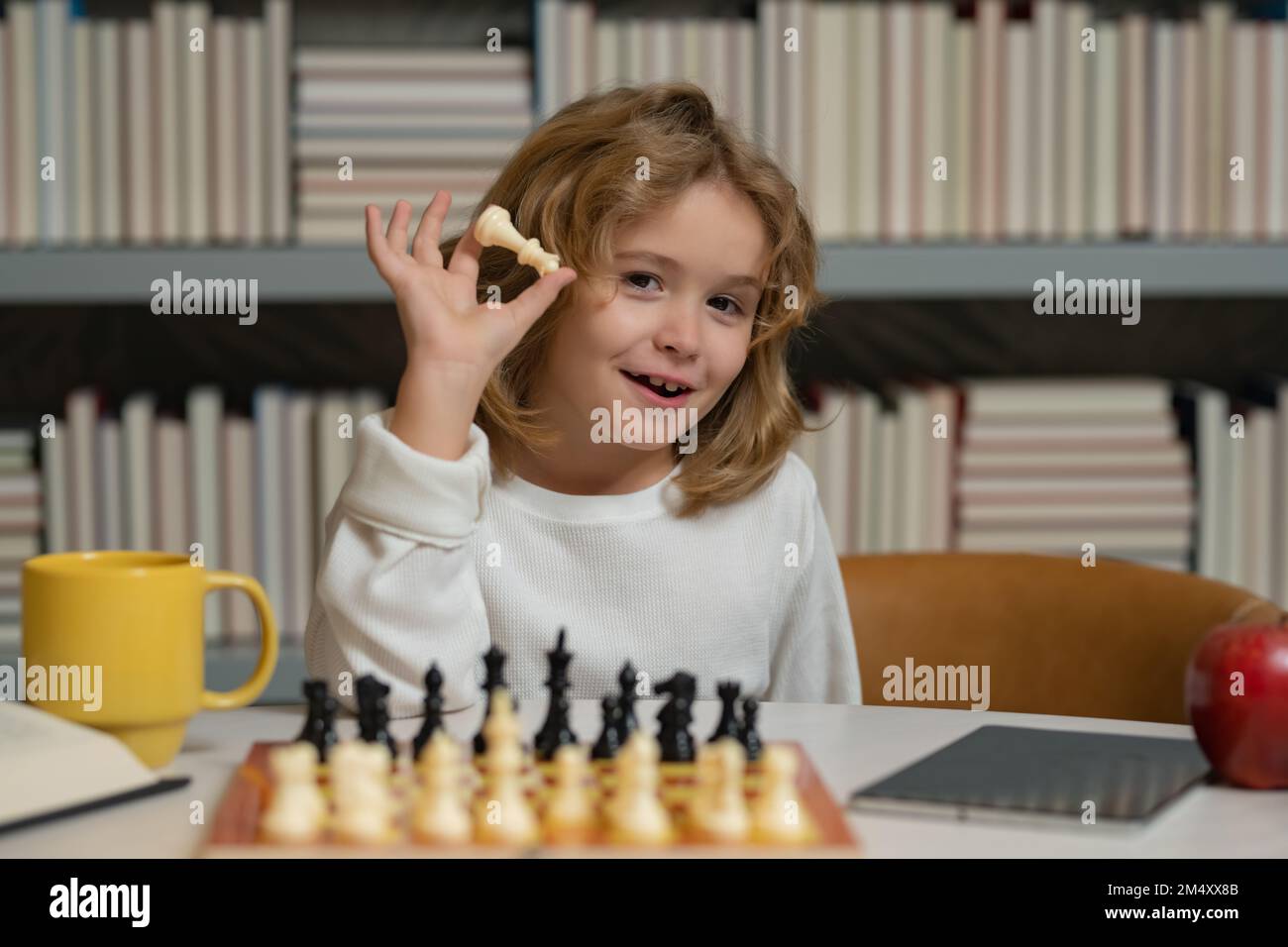Chess game for children. Shool kid playing chess in classroom Stock ...