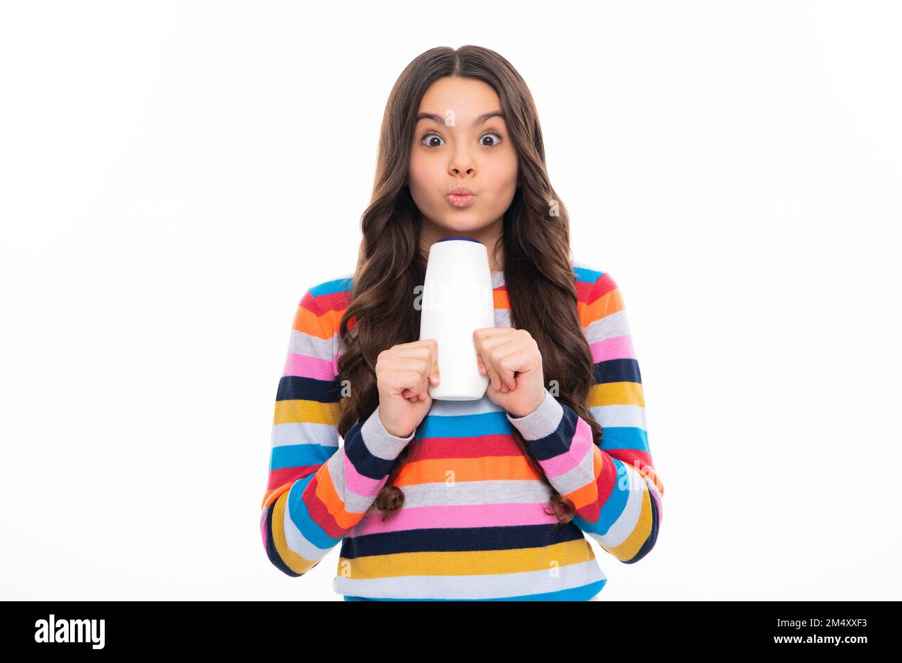 Funny face. Teenager child girl showing bottle shampoo conditioners or ...