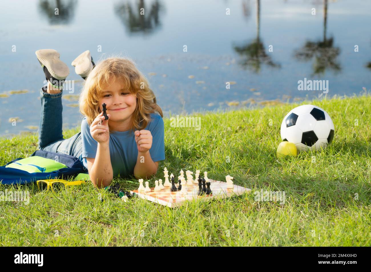 Concentrated kid developing chess strategy, playing board game in ...