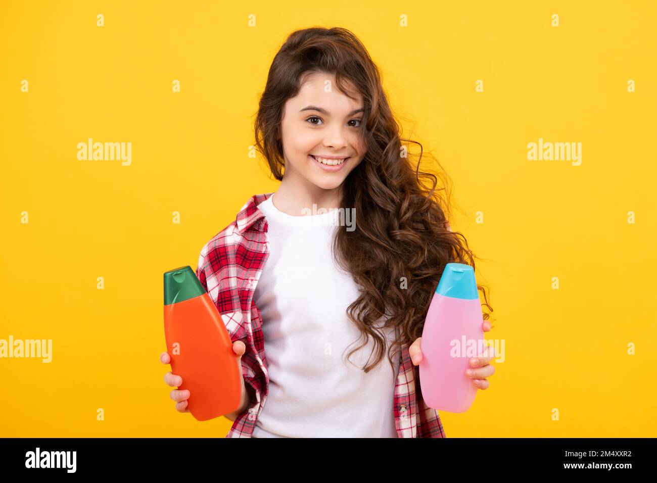 Teenage girl with shampoos conditioners or shower gel. Kids hair care ...