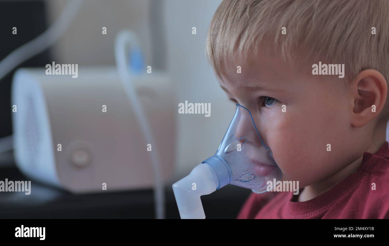 Funny boy breathing through an inhaler mask Stock Photo - Alamy