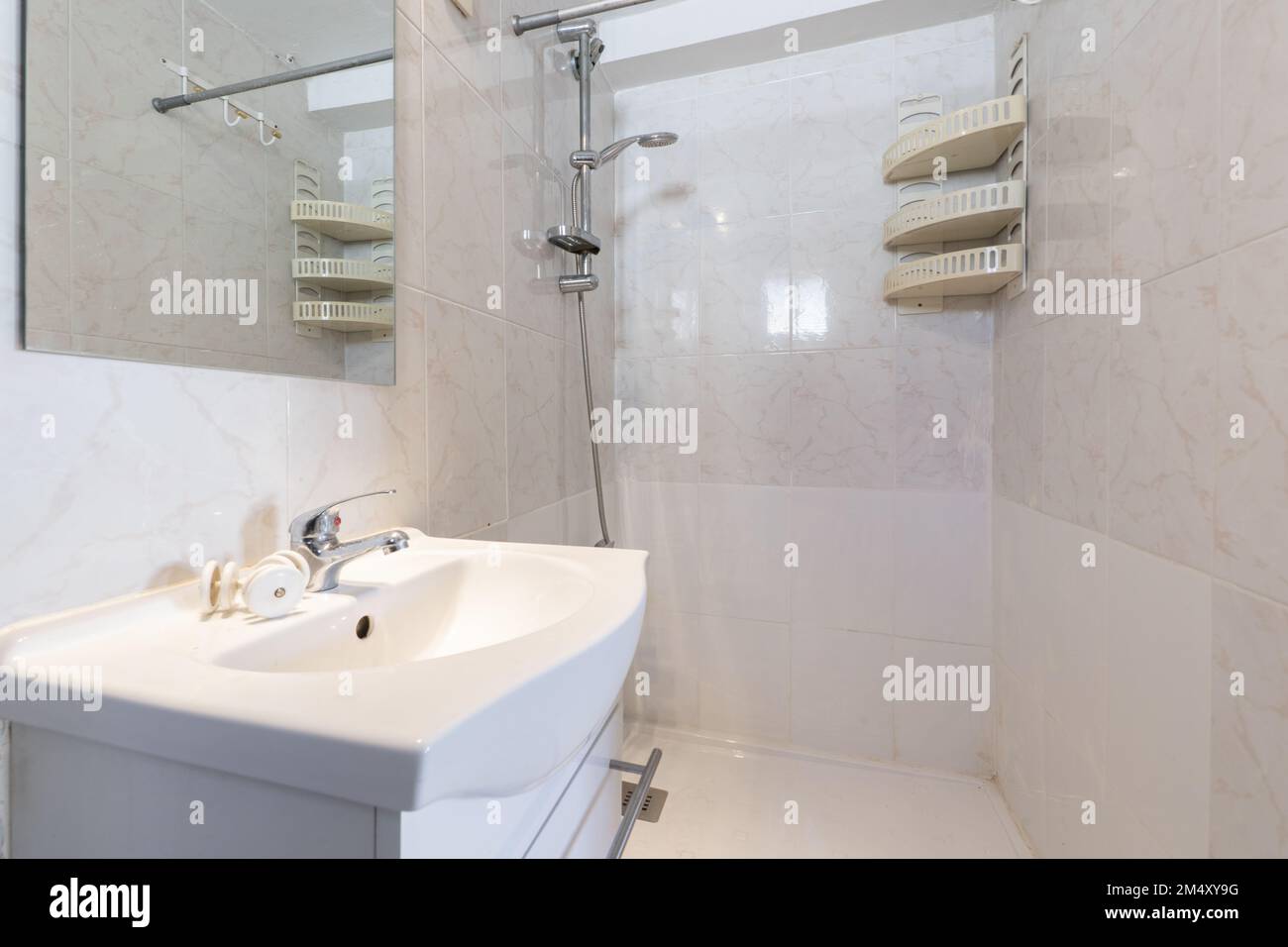 Small bathroom with a white porcelain sink on a wooden cabinet and a ...