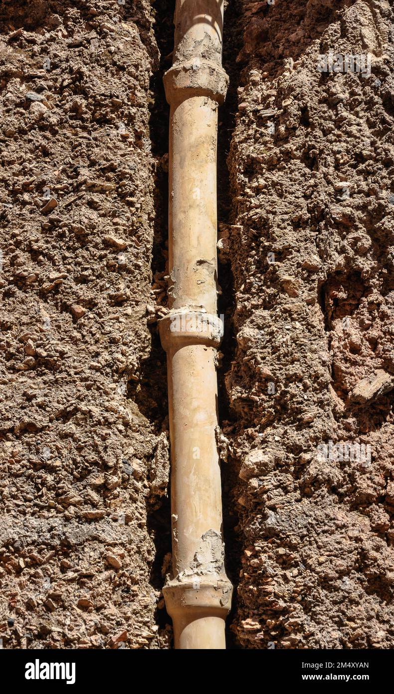 A vertical of the old drain pipe embedded in the wall of the house ...