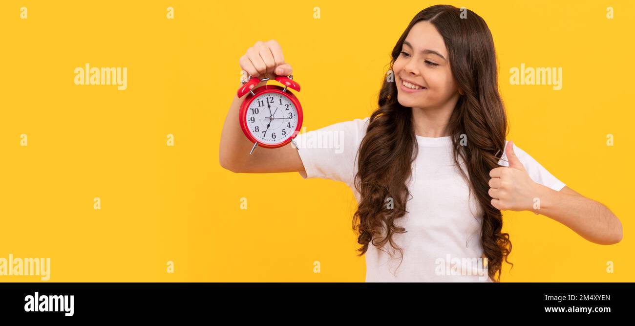happy child hold retro alarm clock showing time, thumb up. Teenager ...